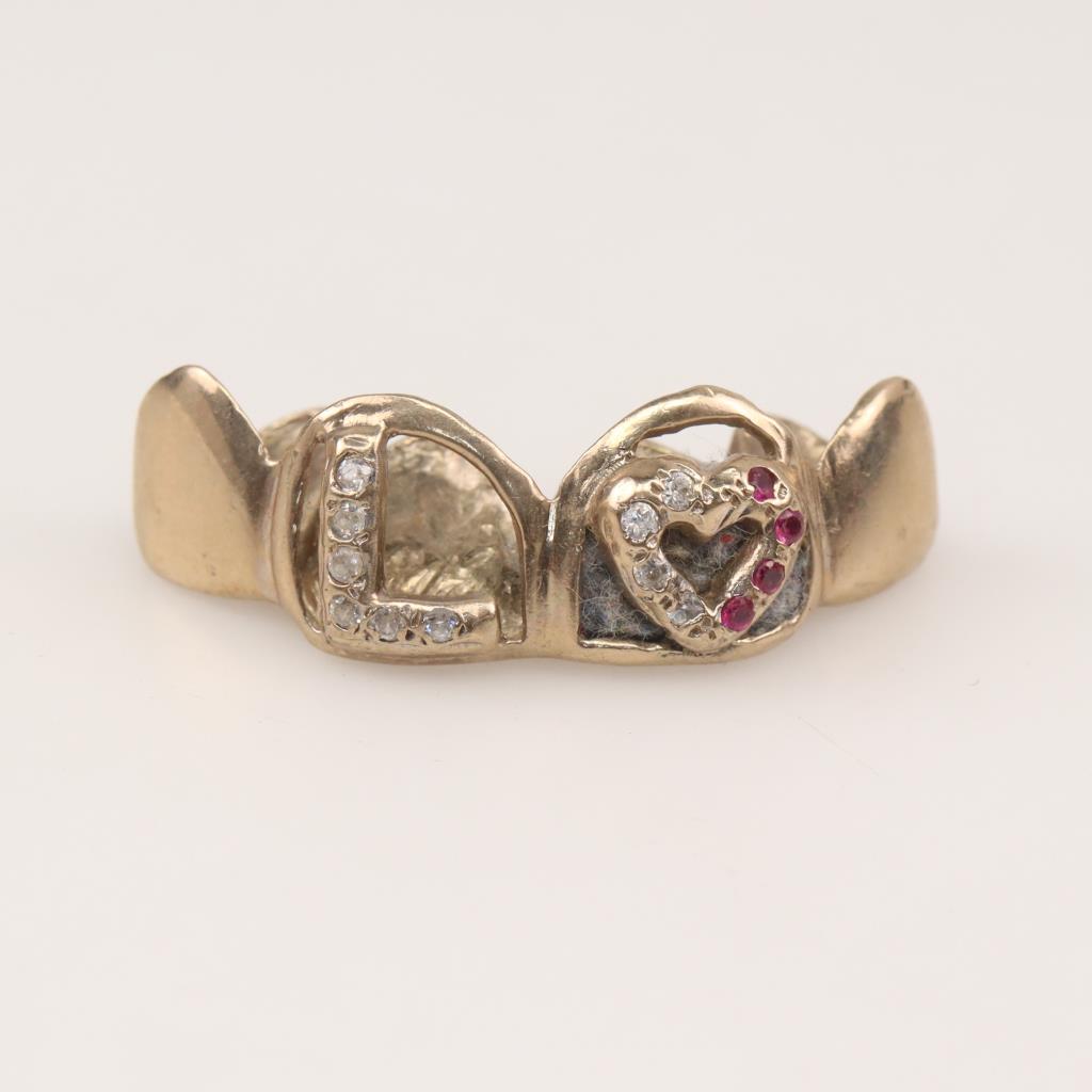 18kt Gold Clear And Red Stone Teeth Caps | Property Room