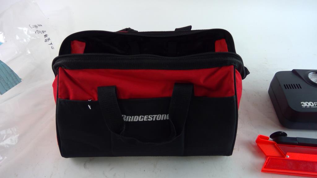 Bridgestone Bag With Unbranded Air Compressor And Triangles | Property Room