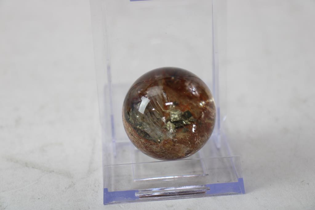 Polished Sphere Stone With Visible Silver Pieces Inside | Property Room