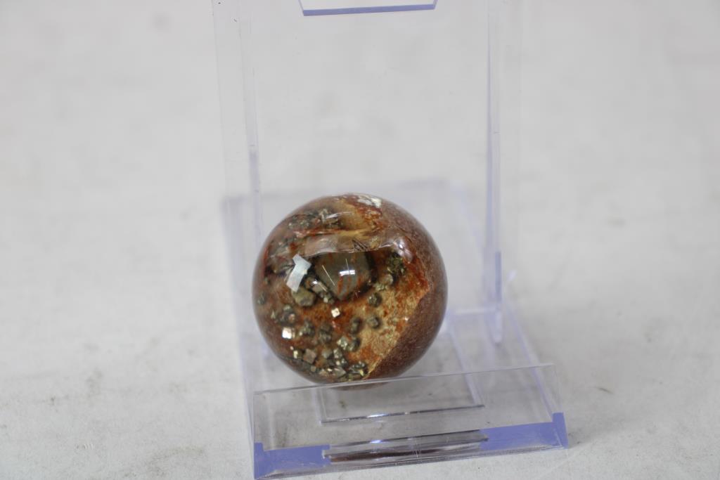 Polished Sphere Stone With Visible Silver Pieces Inside | Property Room