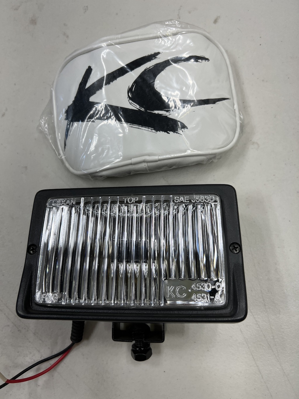 KC HiLites Work / Driving light with cover | Property Room